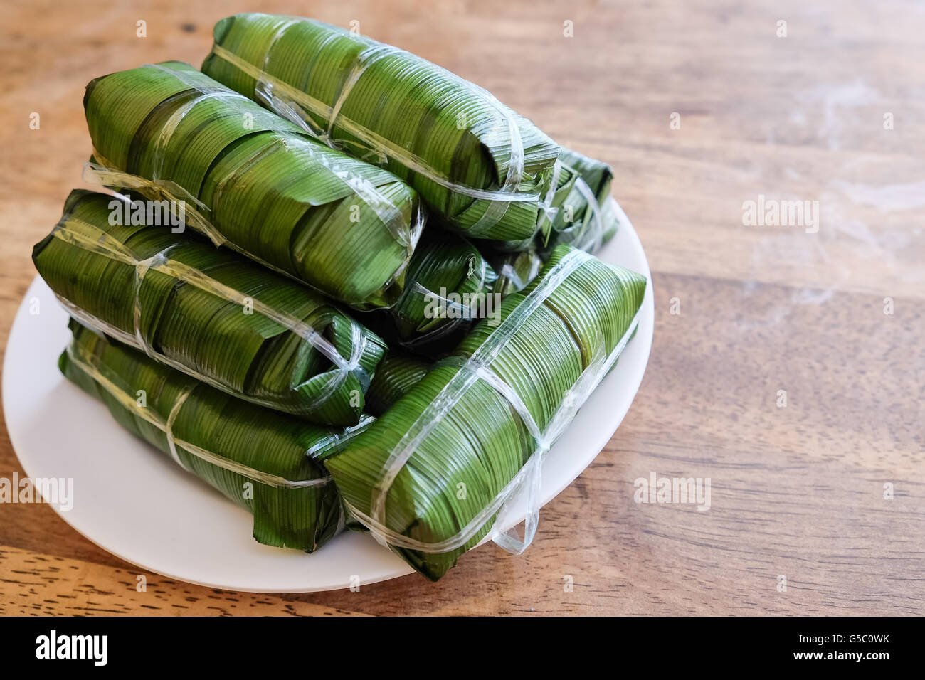 sticky rice cakes. A glutinous rice wrapped in leaves Stock Photo - Alamy