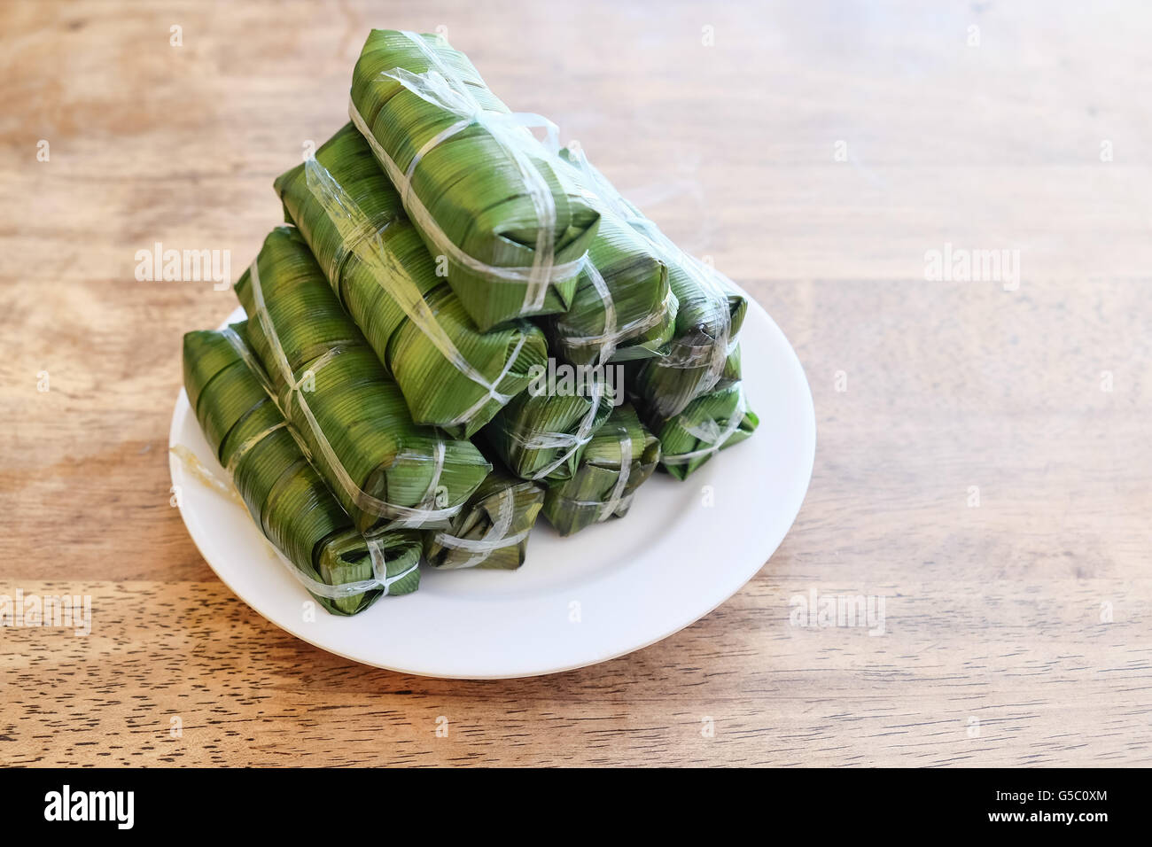 sticky rice cakes. A glutinous rice wrapped in leaves Stock Photo - Alamy