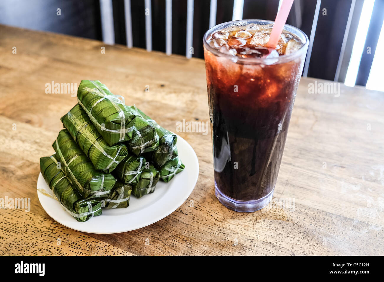 sticky rice cakes. A glutinous rice wrapped in leaves Stock Photo - Alamy
