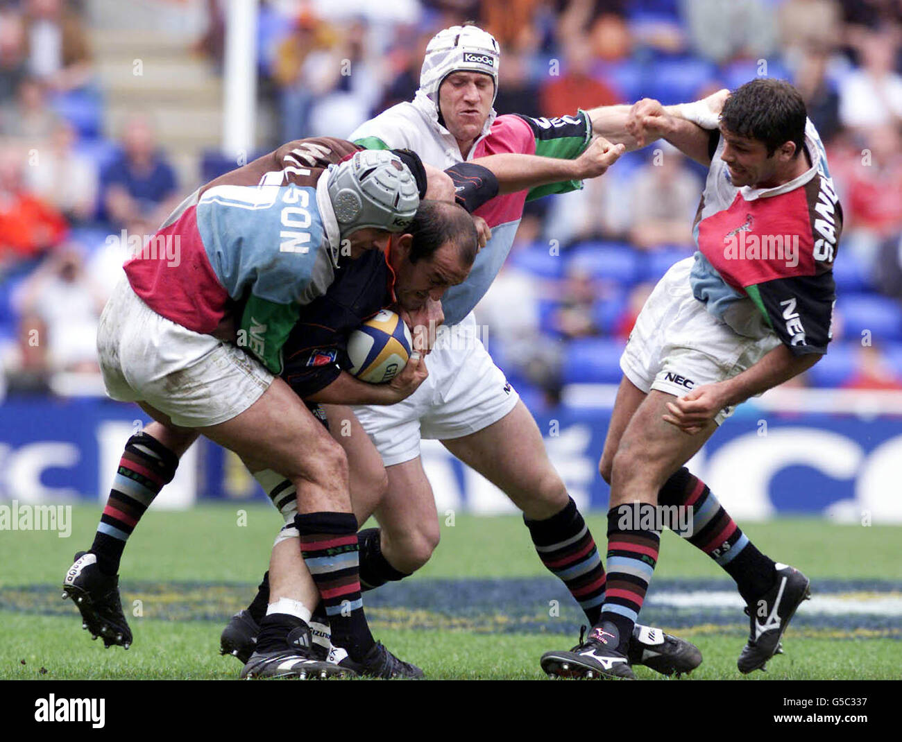 Narbonne's Mario Ledesma is held by Harlequin's captain David Wilson ...