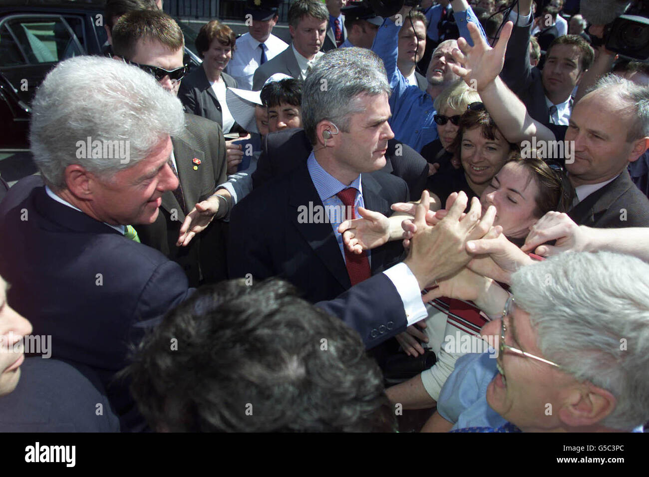 Crowds gather to shake hands with former US Preident Bill Clinton ...