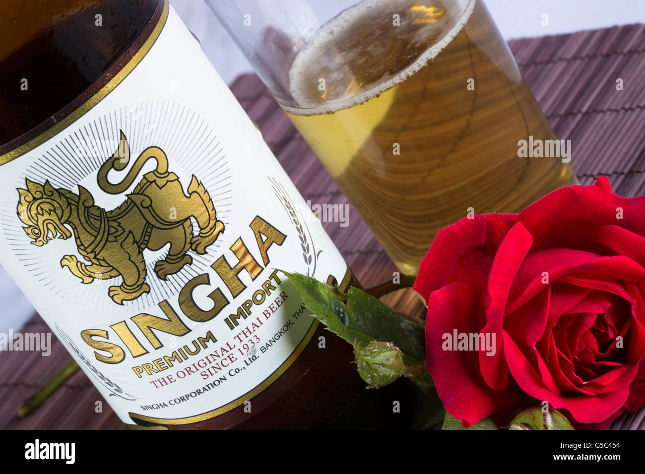 Abstract view of a cold bottle of Thai Beer, Singha, partly poured into ...