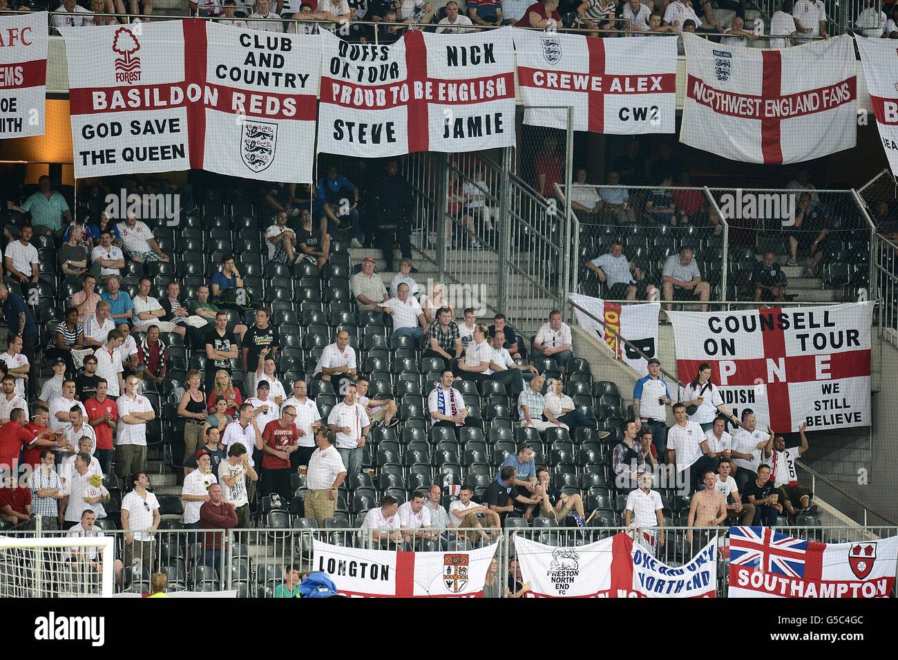 England fans hang giant flags as they cheer on their side in the stands ...