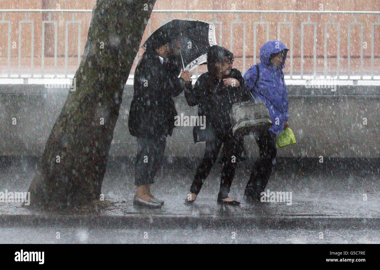 Three women shelter from heavy rain hail storm in london hi-res stock ...