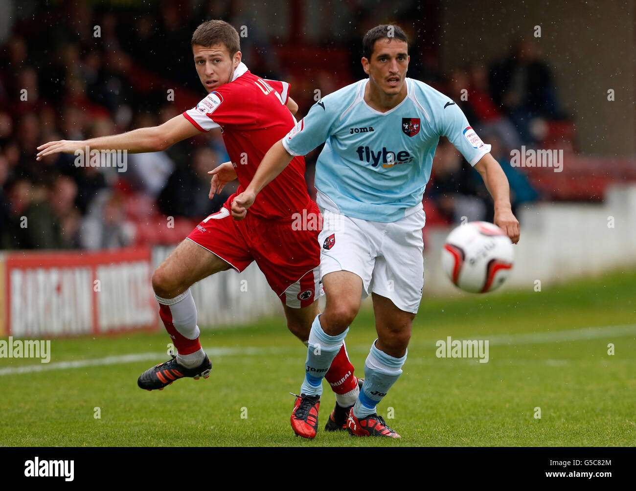 Accrington Stanley's Craig Lindfield (left) in action with Exeter City ...