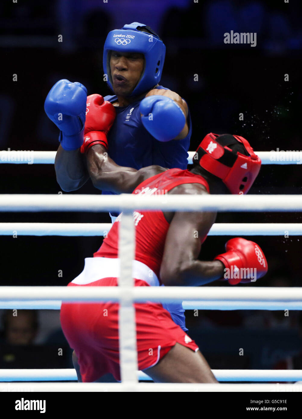 Great Britain's Anthony Joshua (top) takes on Cuba's Erislandy Savon ...