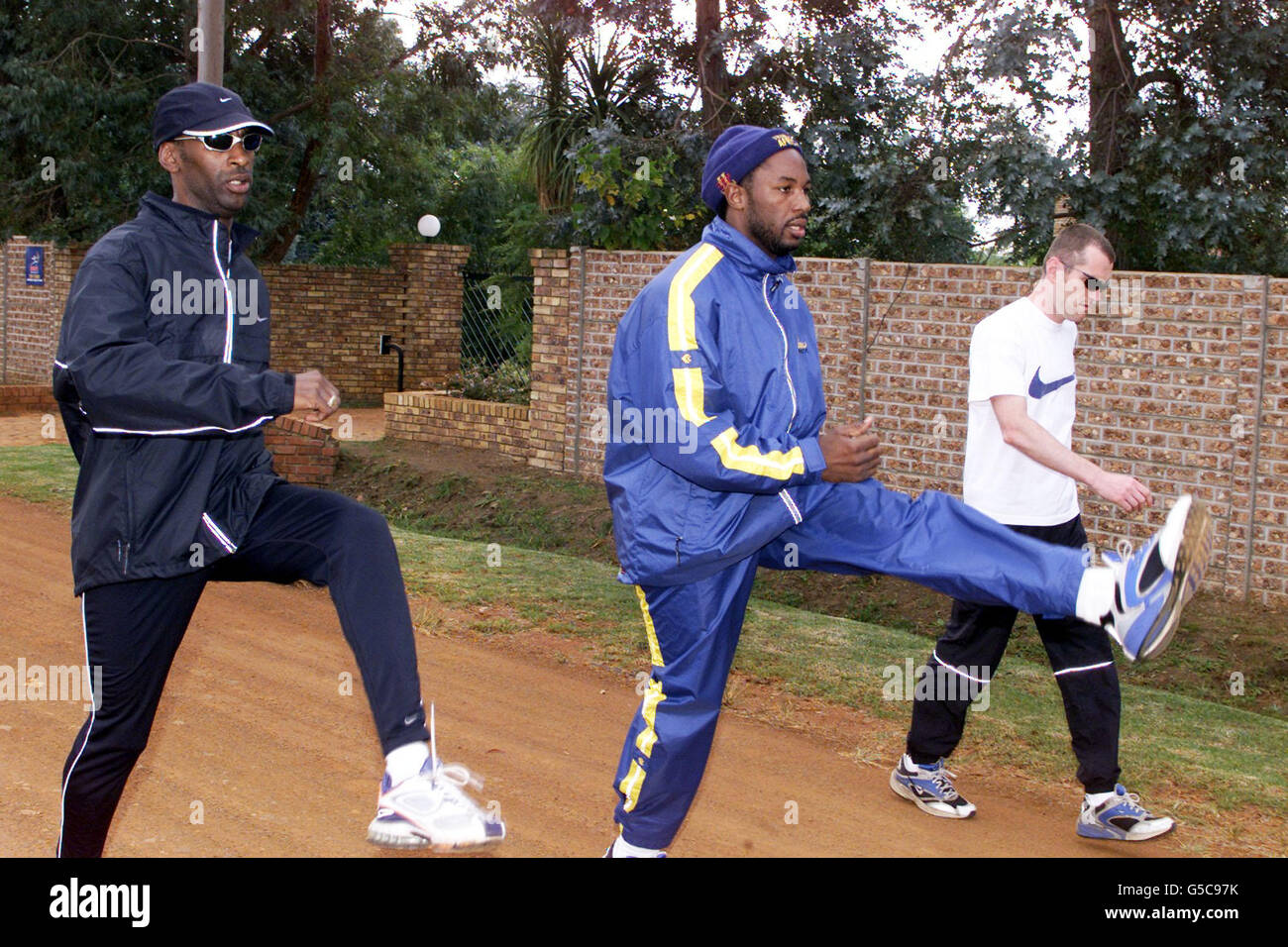 Heavyweight boxer Lennox Lewis (centre) takes part in a light jogging ...
