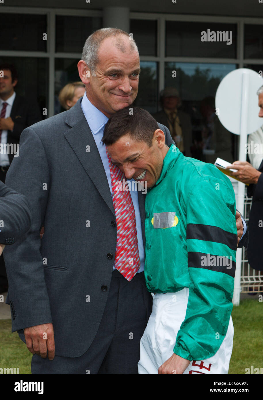 Frankie Dettori (right) is embraced by trainer Brian Meehan in the ...