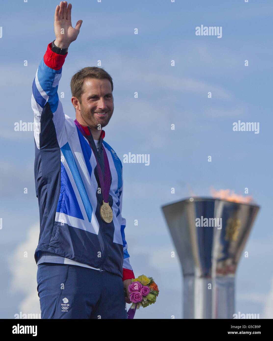 Great Britain's Finn sailor Ben Ainslie celebrates winning his fourth ...