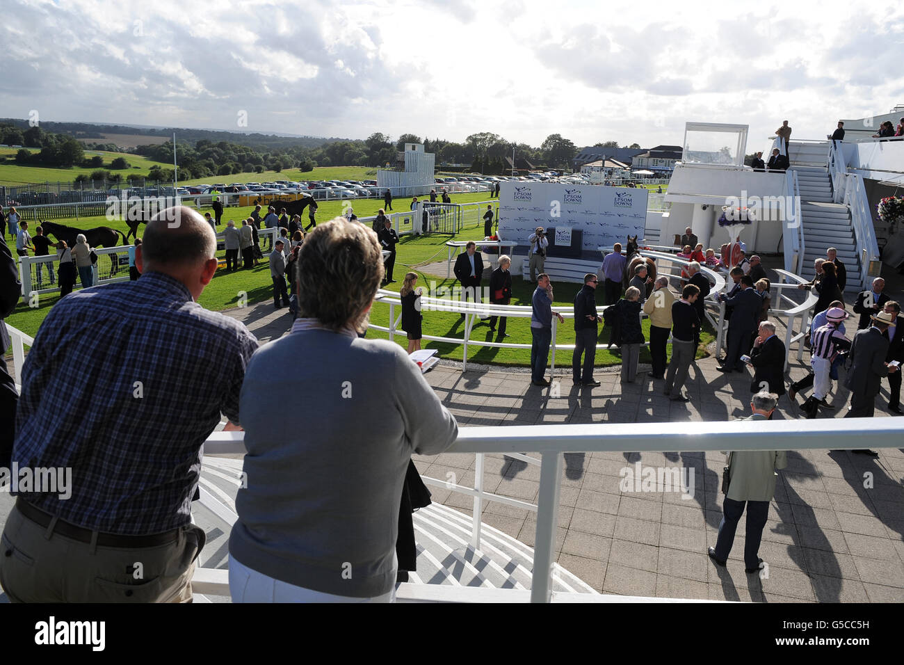 Racegoers look on at the winners enclosure at Epsom Downs Racecourse ...