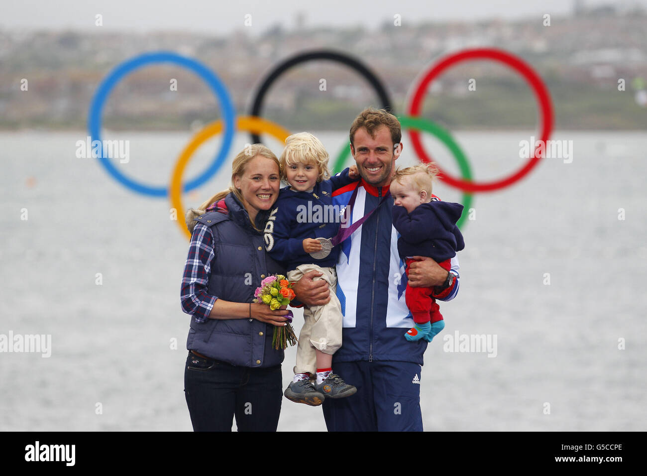 Great Britain's Nick Dempsey celebrates winning silver, with his wife ...