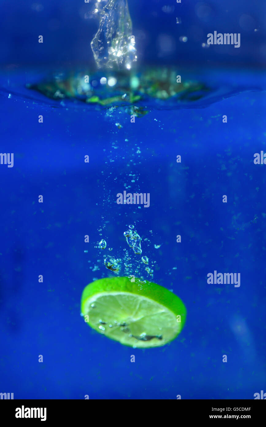 Fresh lime with water splash Stock Photo - Alamy