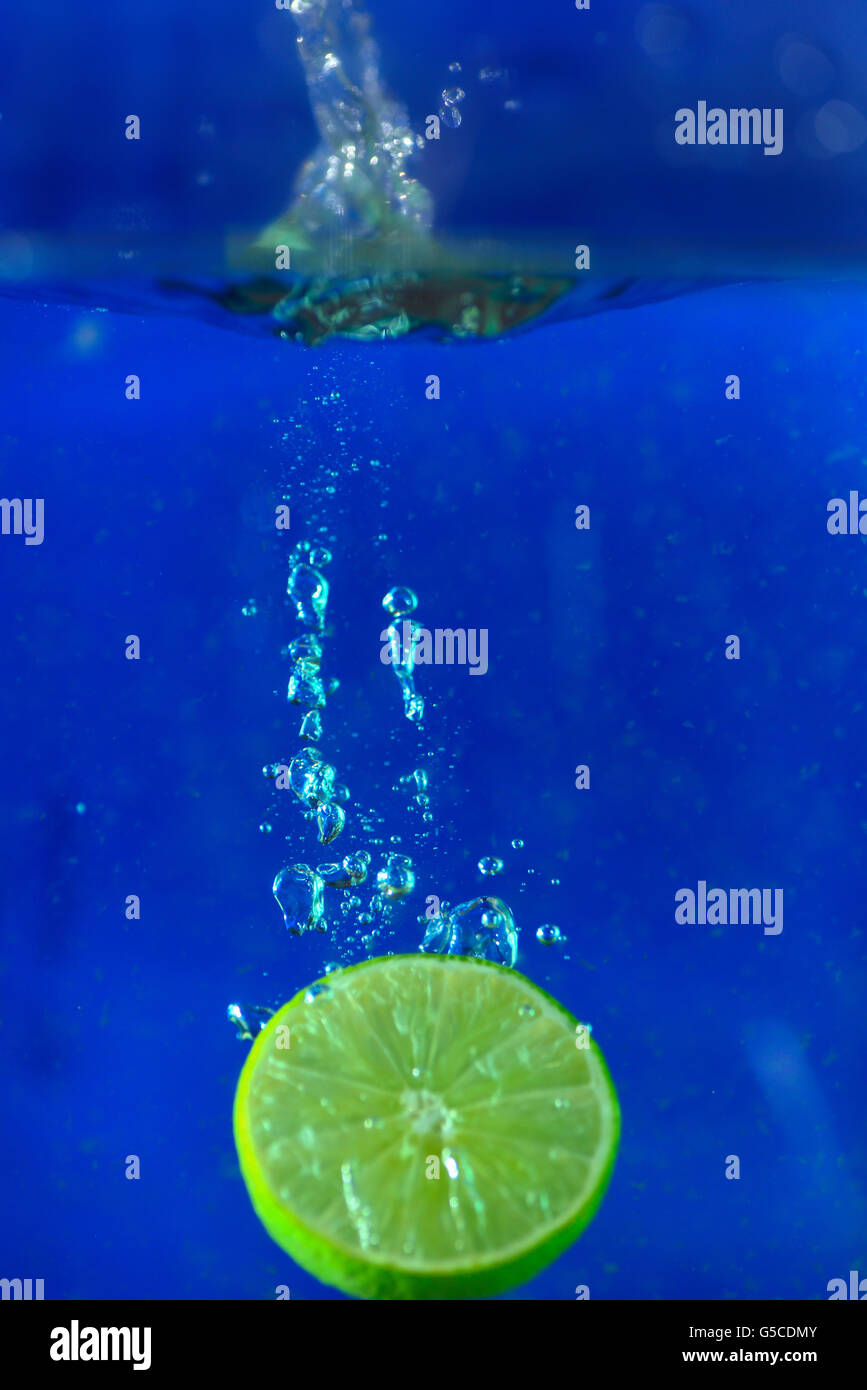 Fresh lime with water splash Stock Photo - Alamy