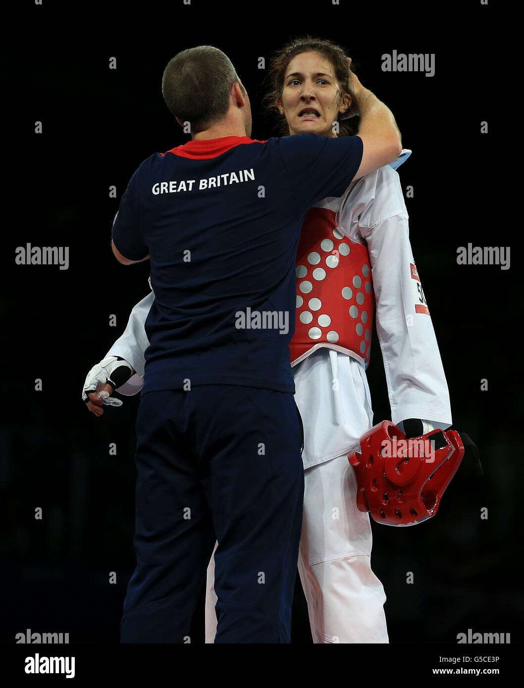 Great Britain's Sarah Stevenson is consoled by her coach and husband ...