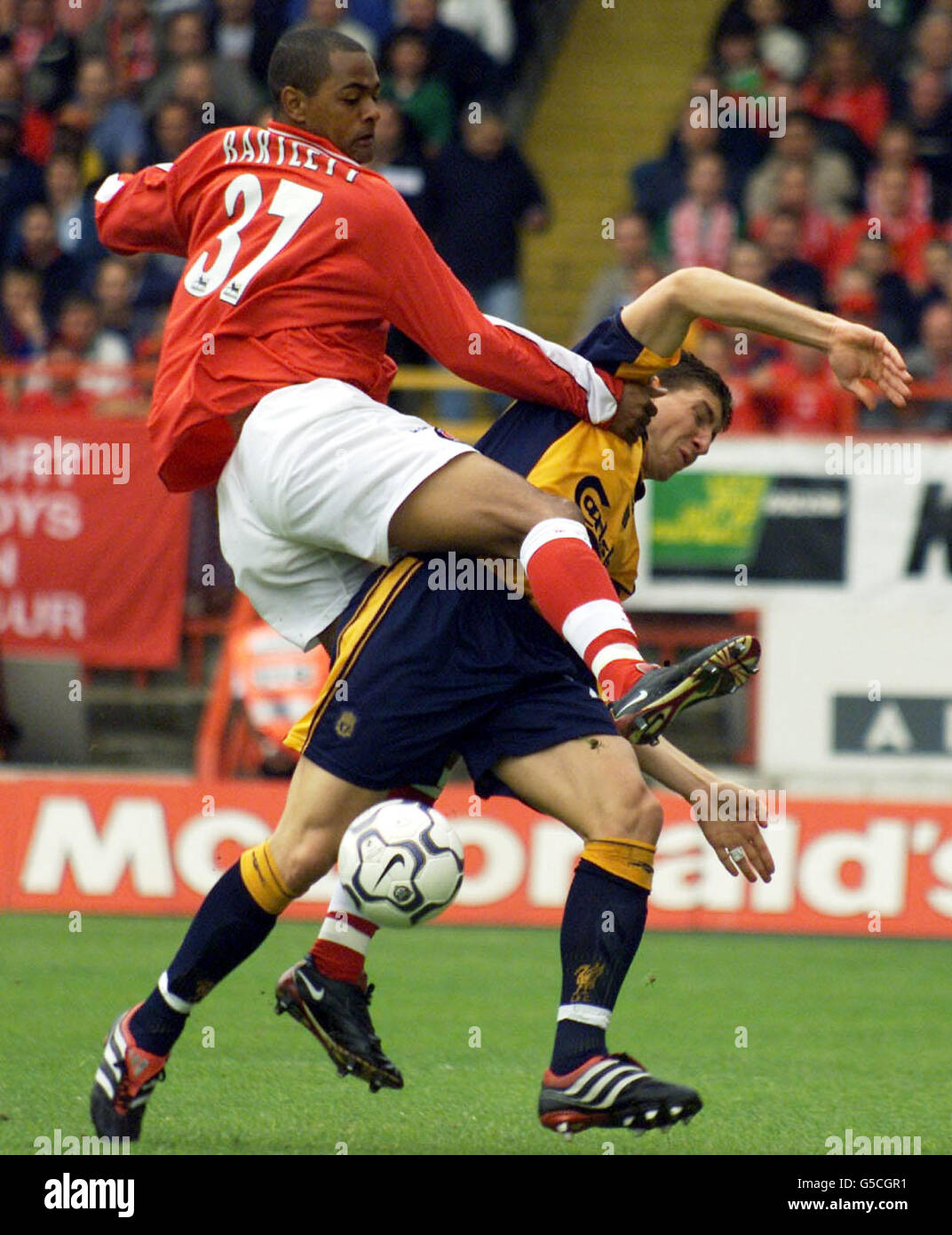 Charlton's Shaun Bartlett (left) battles for the ball with Liverpool's ...