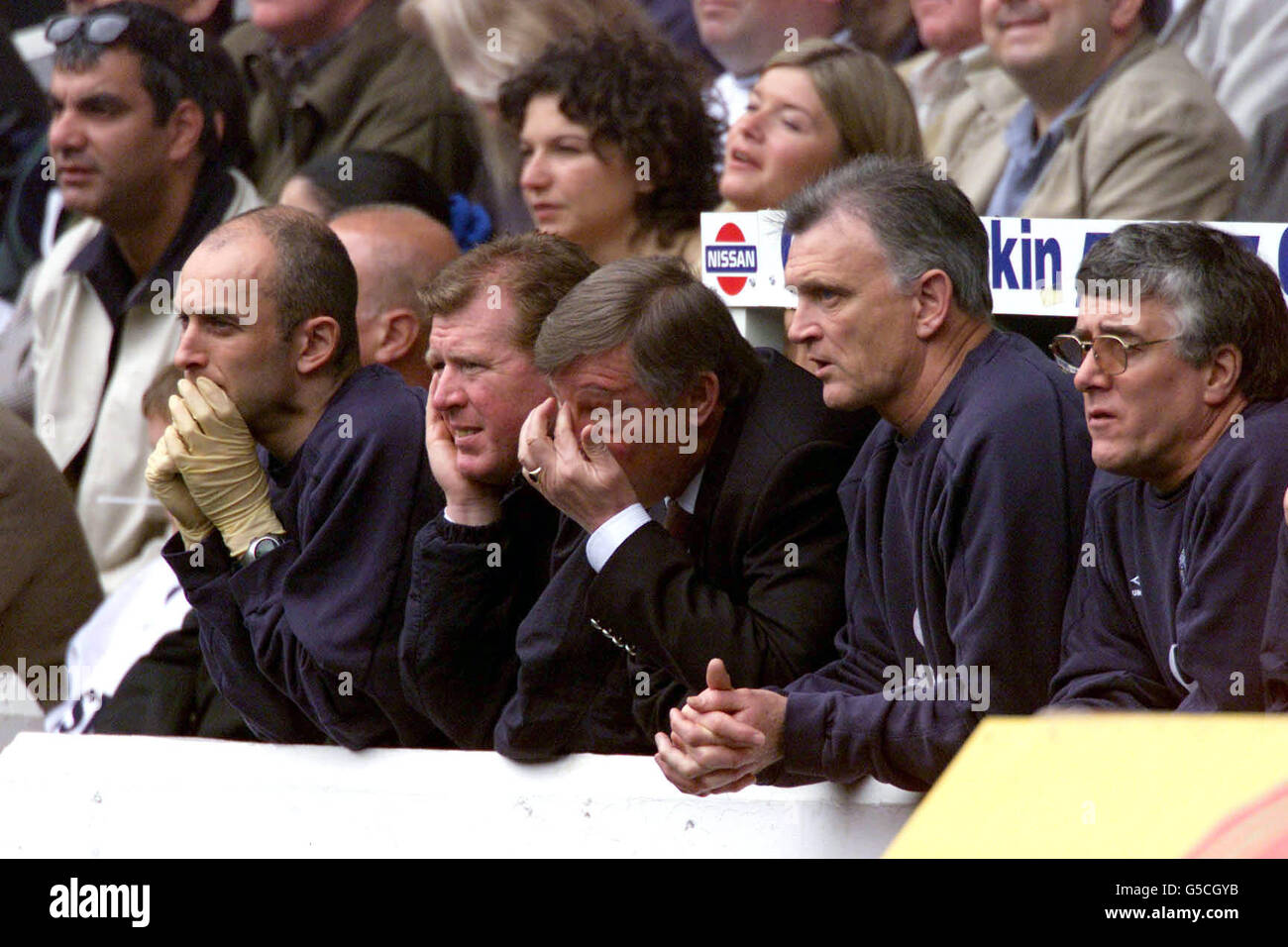 Manchester United's Manager Sir Alex Ferguson (third right) sits on the ...