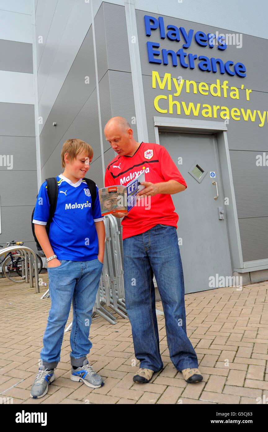 Cardiff fans wearing both the Red and Blue kit stand in front of the ...