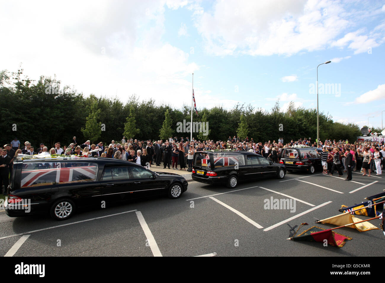 Friends and family lay flowers on the hearses of, Lieutenant Andrew ...