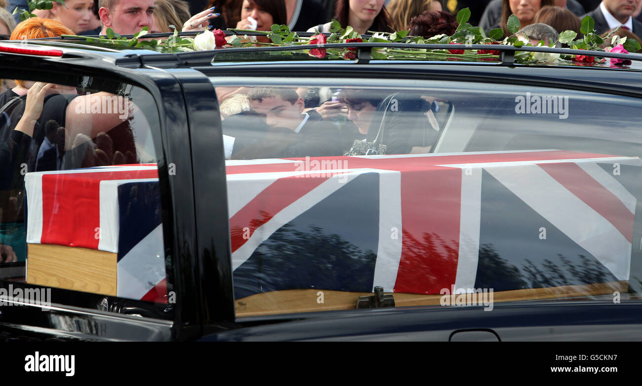 Friends and family lay flowers on the hearses of, Lieutenant Andrew ...