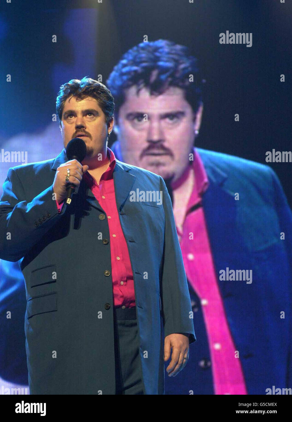 Comedian Phill Jupitus performing on stage during the 'We Know Where ...