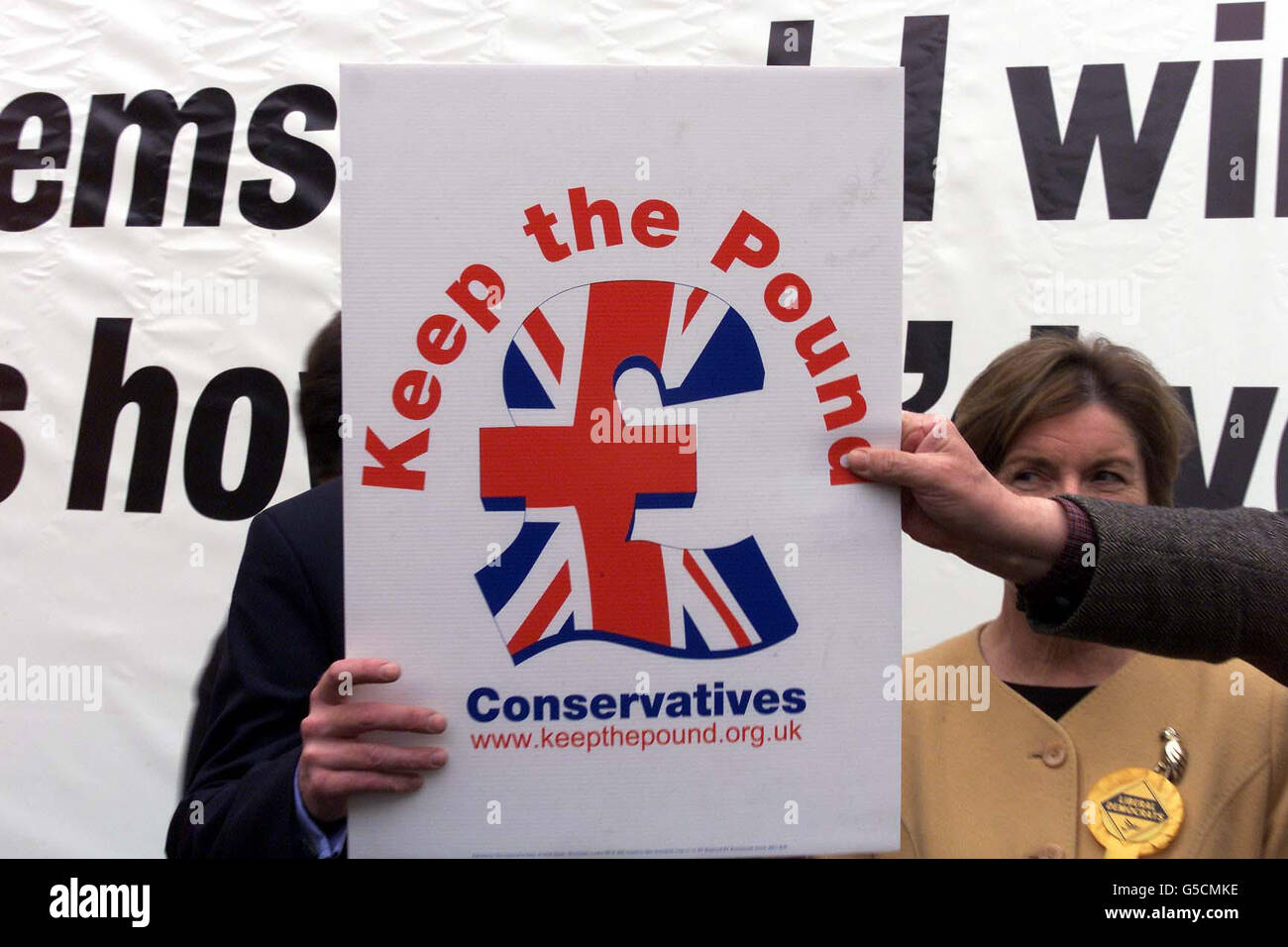 A Tory poster is placed in front of Liberal Democrat leader Charles ...