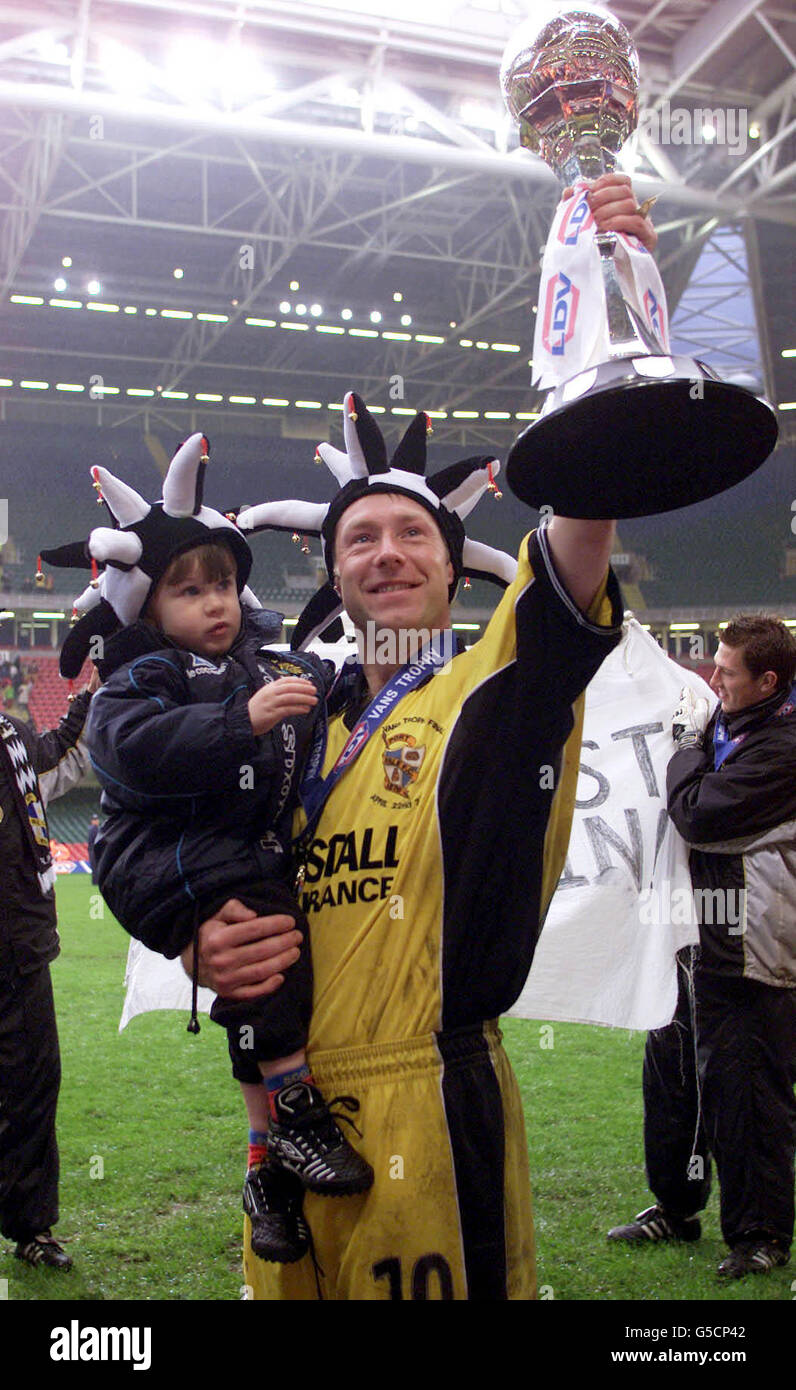 Port Vale's Tony Naylor parades the trophy to the fans after victory ...