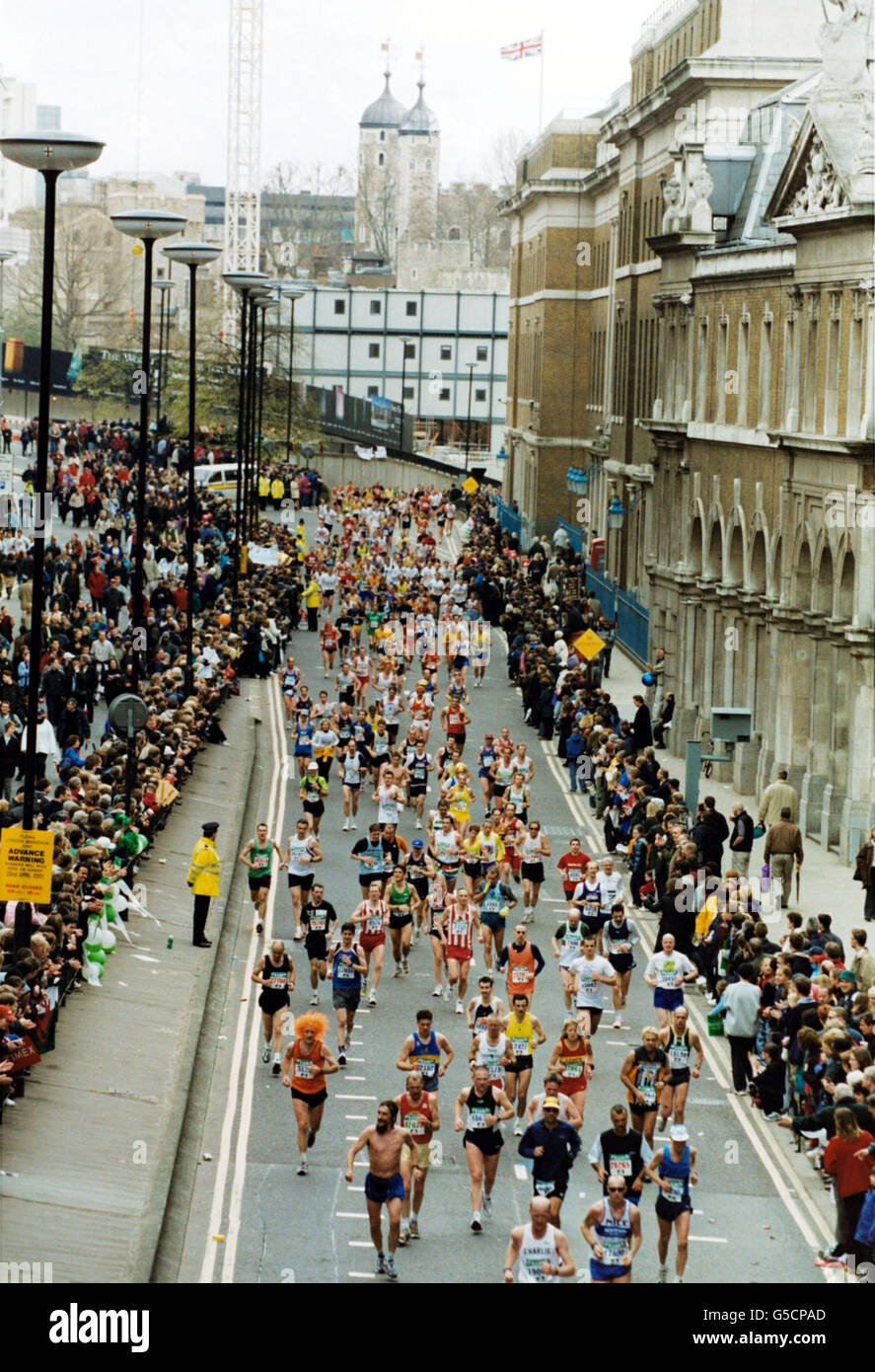 Contestants in action during the 2001 London Marathon are cheered on by ...