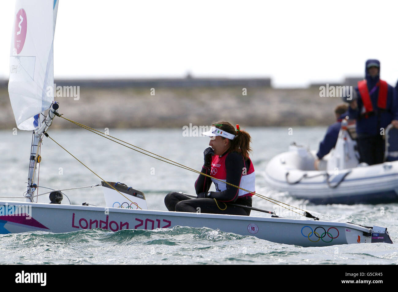 Ireland's Annalise Murphy sits dejected in her boat as she reflects on ...