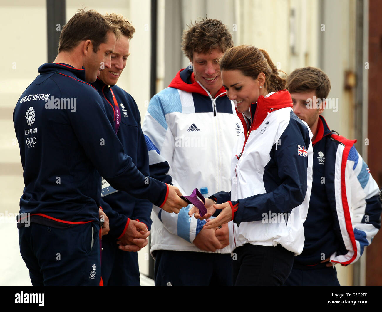 Duchess of Cambridge is shown his gold medalist by Ben Ainslie (left ...