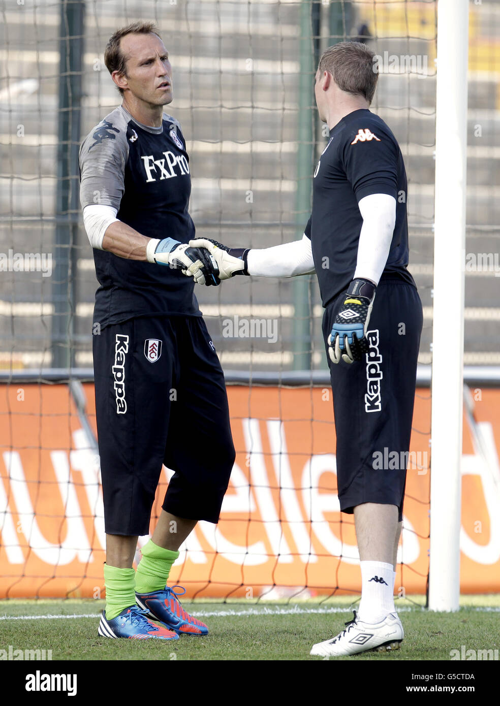Fulham goalkeeper Mark Schwarzer shakes hands with team-mate David ...