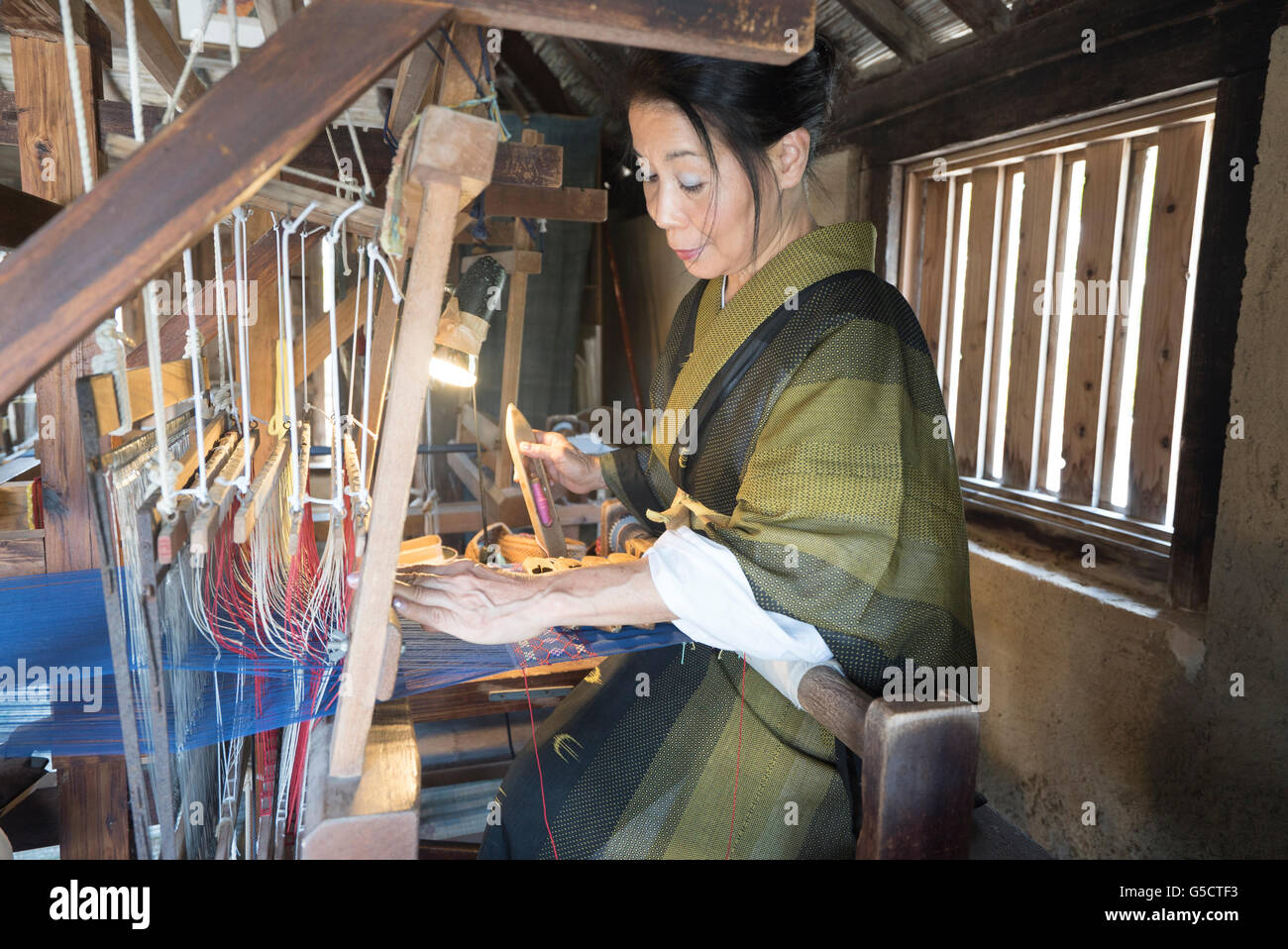 Traditional weaving on a loom at Ryukyu Mura, Okinawa, Japan Stock ...
