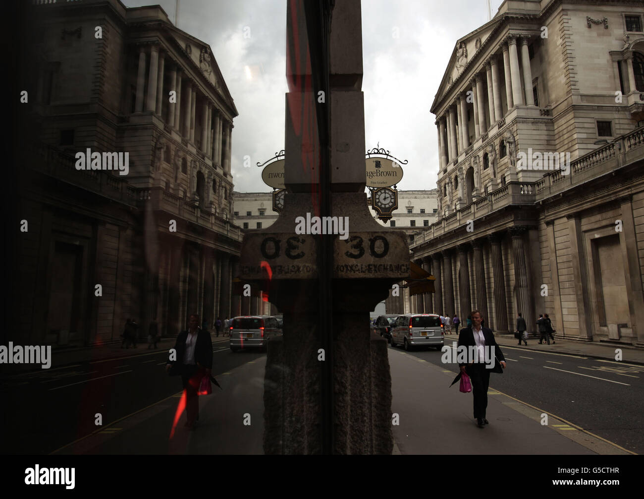 The Bank of England is reflected in a window in the City of London, as ...