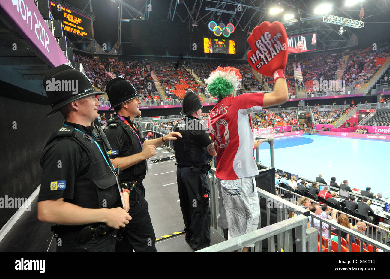 Police and a handball fan in the Handball Arena at the Olympic Park ...