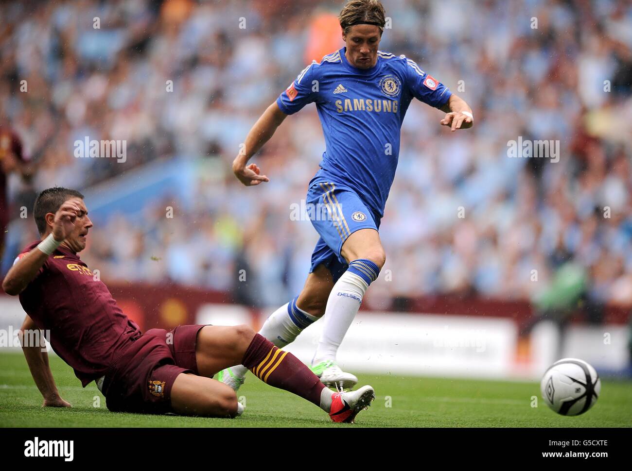 Chelsea's Fernando Torres (right) skips past the challenge from ...