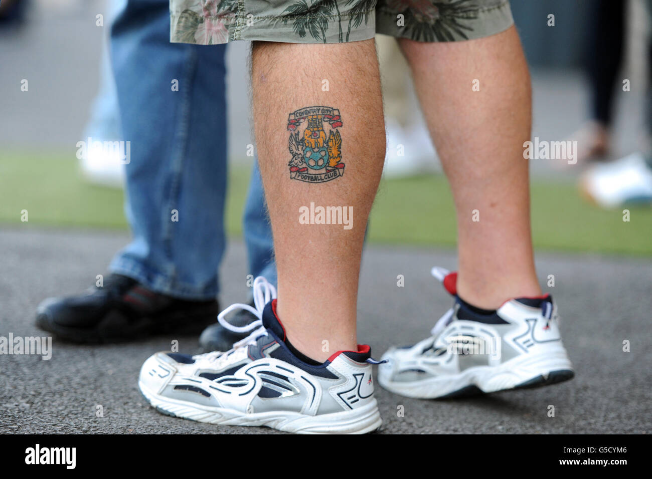 Detail of a Coventry City tattoo on the calf of a fan outside the ...
