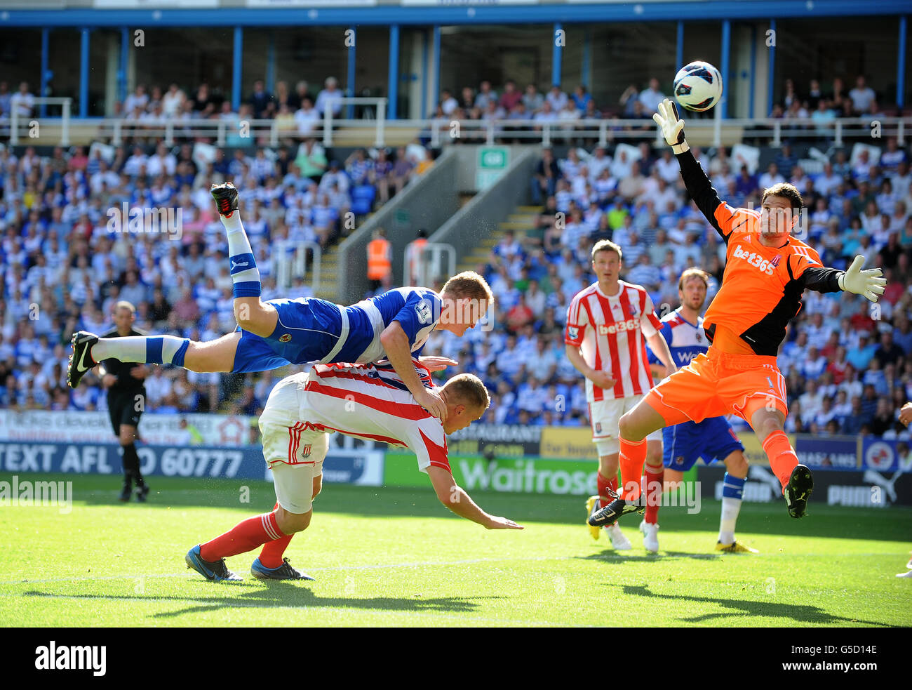 Reading's Alex Pearce (left) beats Stoke City's Ryan Shawcross to the ...