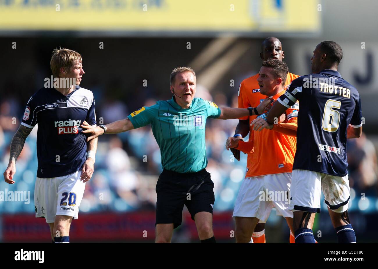 Referee Oliver Langford separate's Millwall's Andy Keogh and Blackpool ...