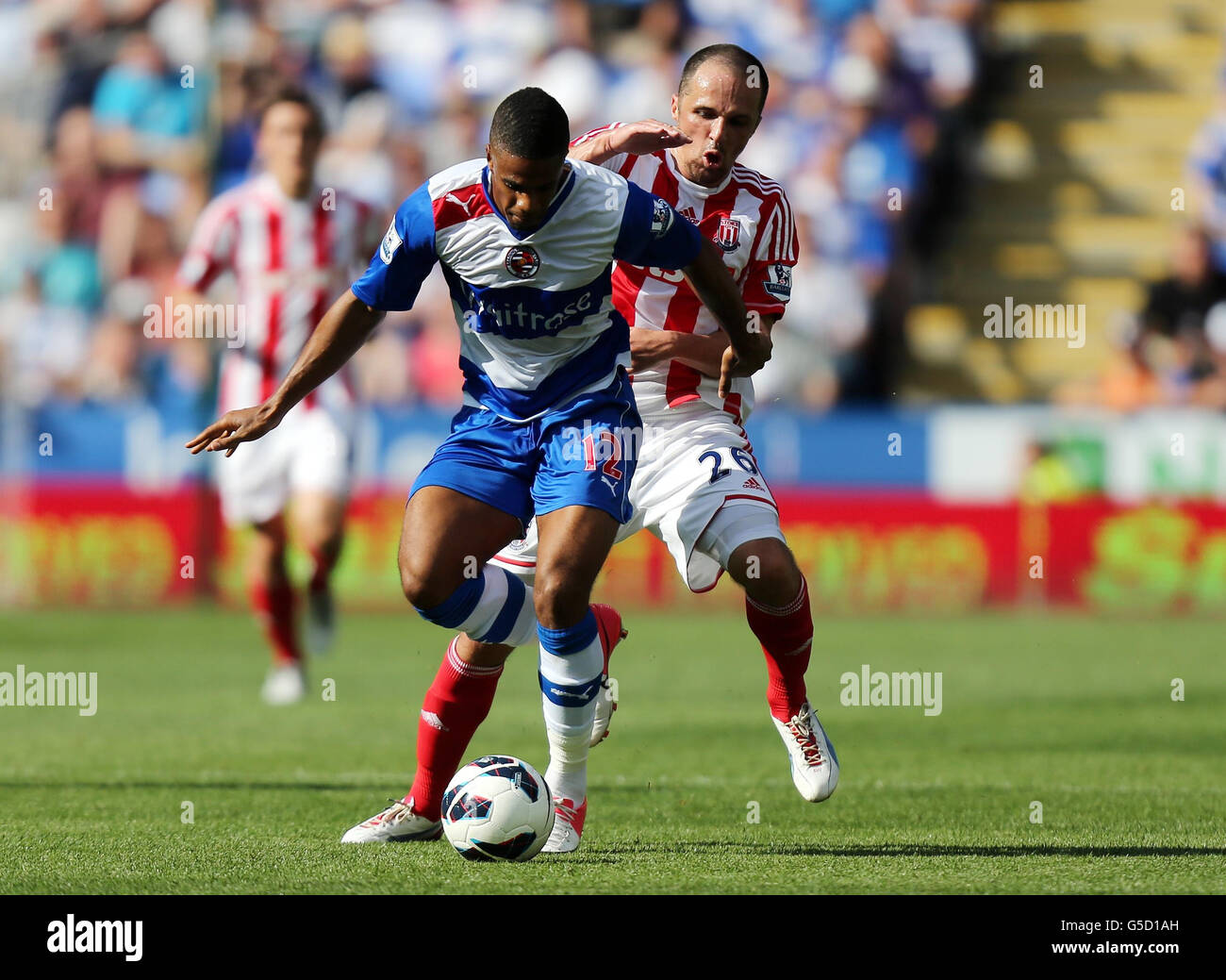 Reading's Garath McCleary is tackled by Stoke's Matthew Etherington ...
