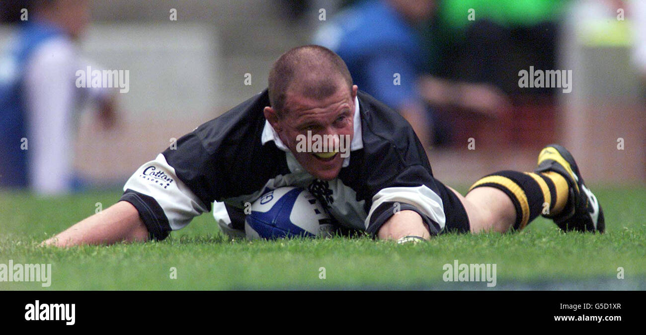 Barbarians player Adrian Garvey runs in a try against England to seal ...