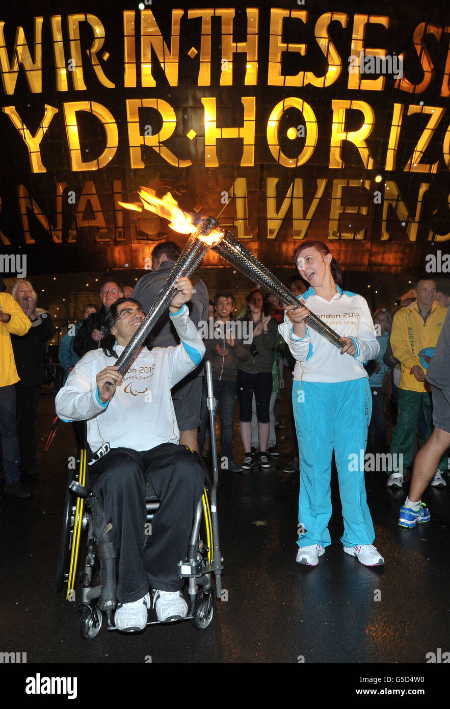 Torchbearer Robyn Johnson hands over the Paralympic flame to ...