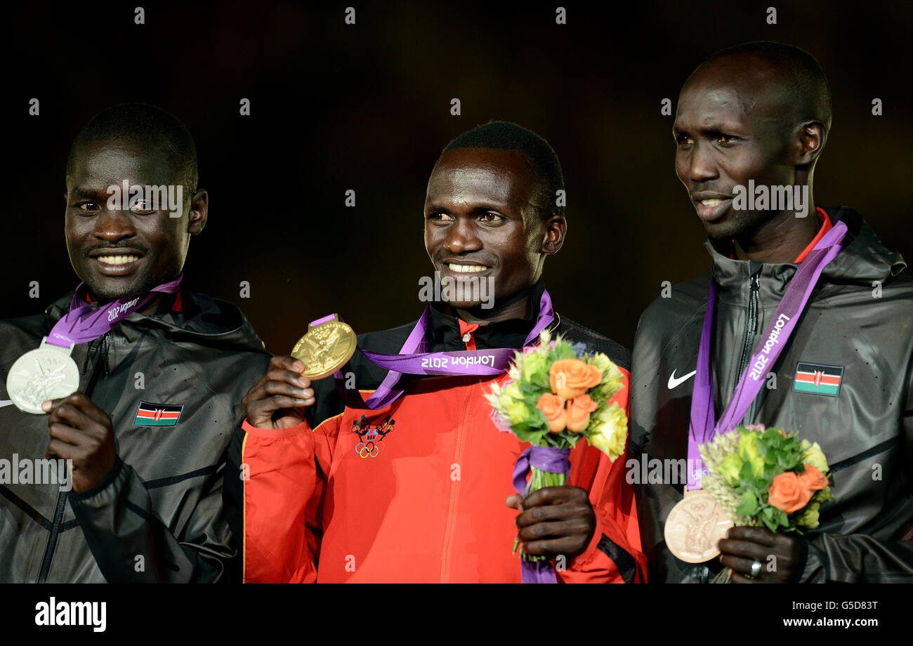 Uganda's Stephen Kiprotich (centre) with his gold medal that was ...