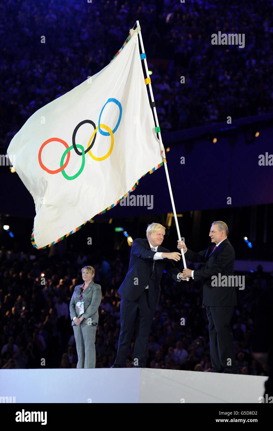 London Mayor Boris Johnson (left) hands the Olympic Flag to IOC ...