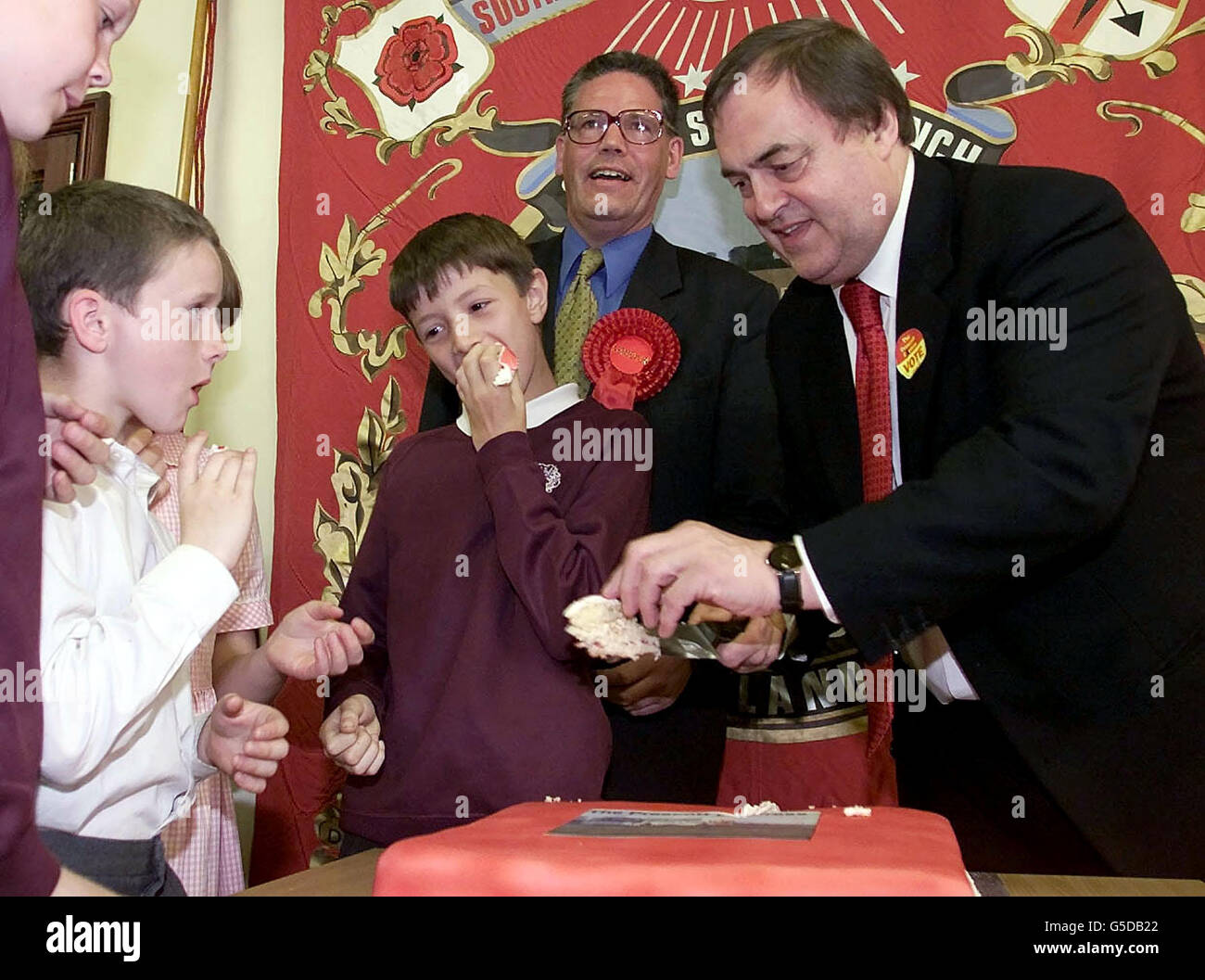 Deputy Prime Minister John Prescott (right) dishes out cake to school ...