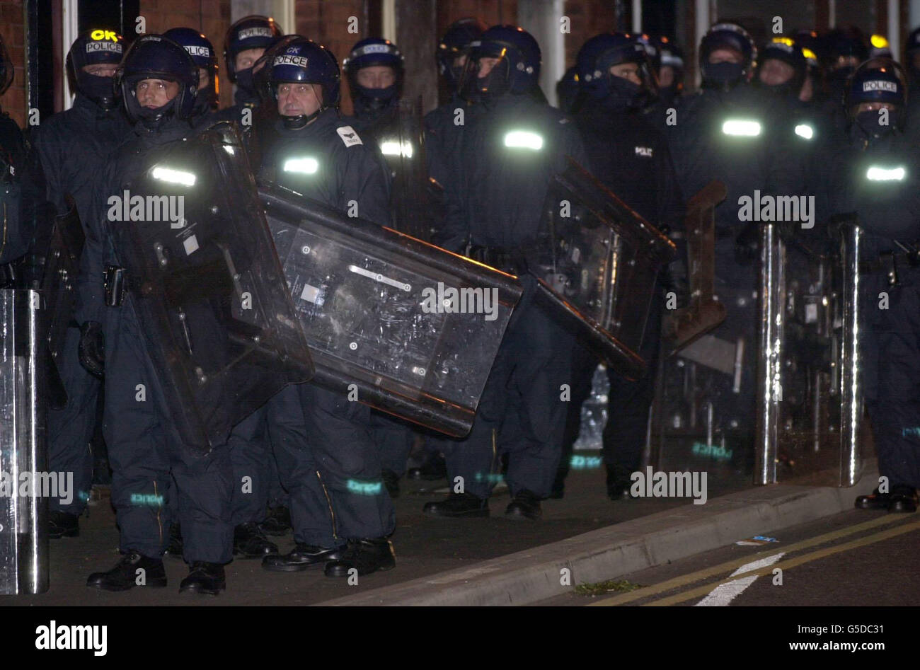 Police in full riot gear mobilize on the streets of Oldham in the early ...
