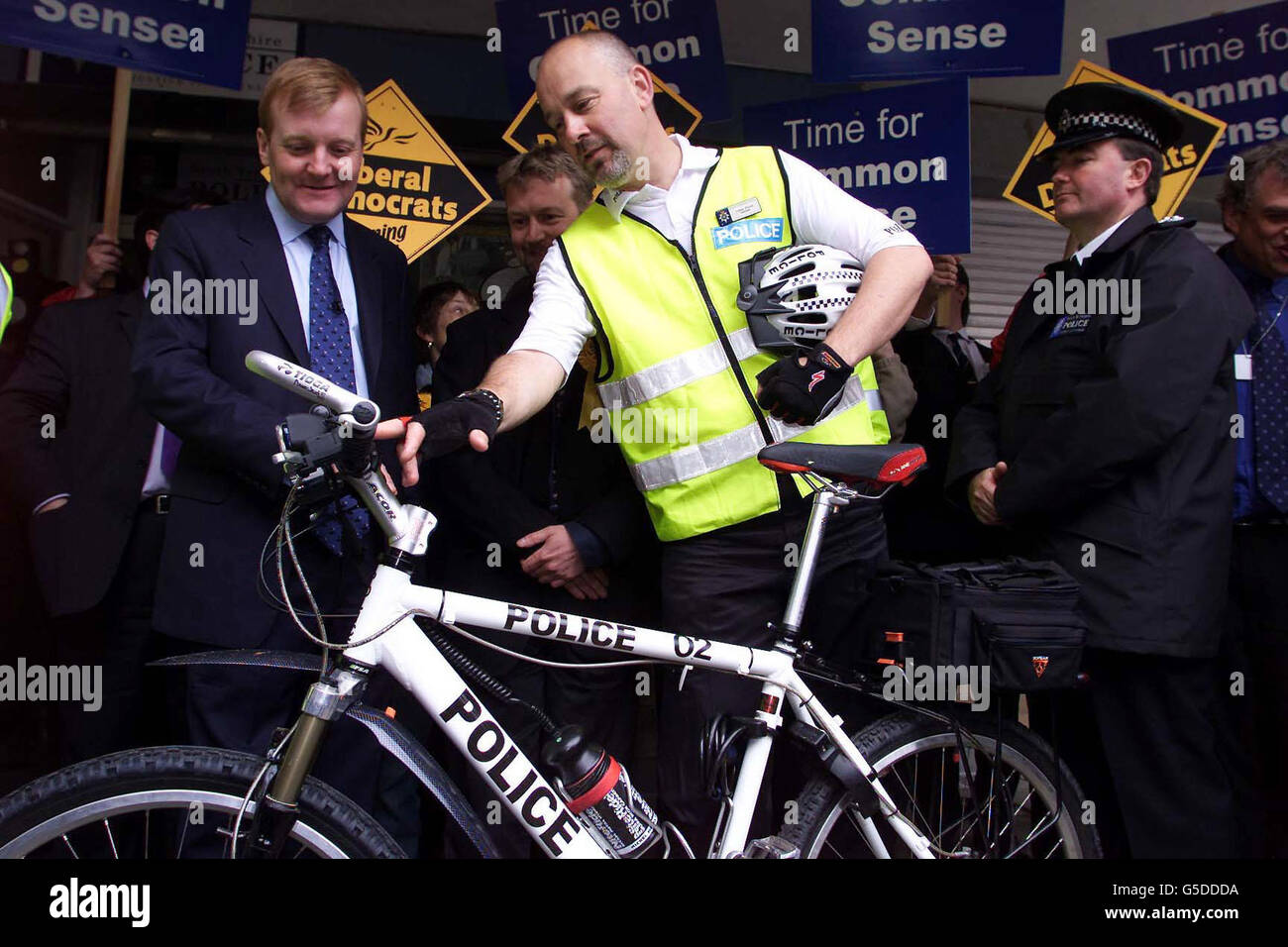 PC Adam Priest (centre) shows his mountain bike to Liberal Democrat ...