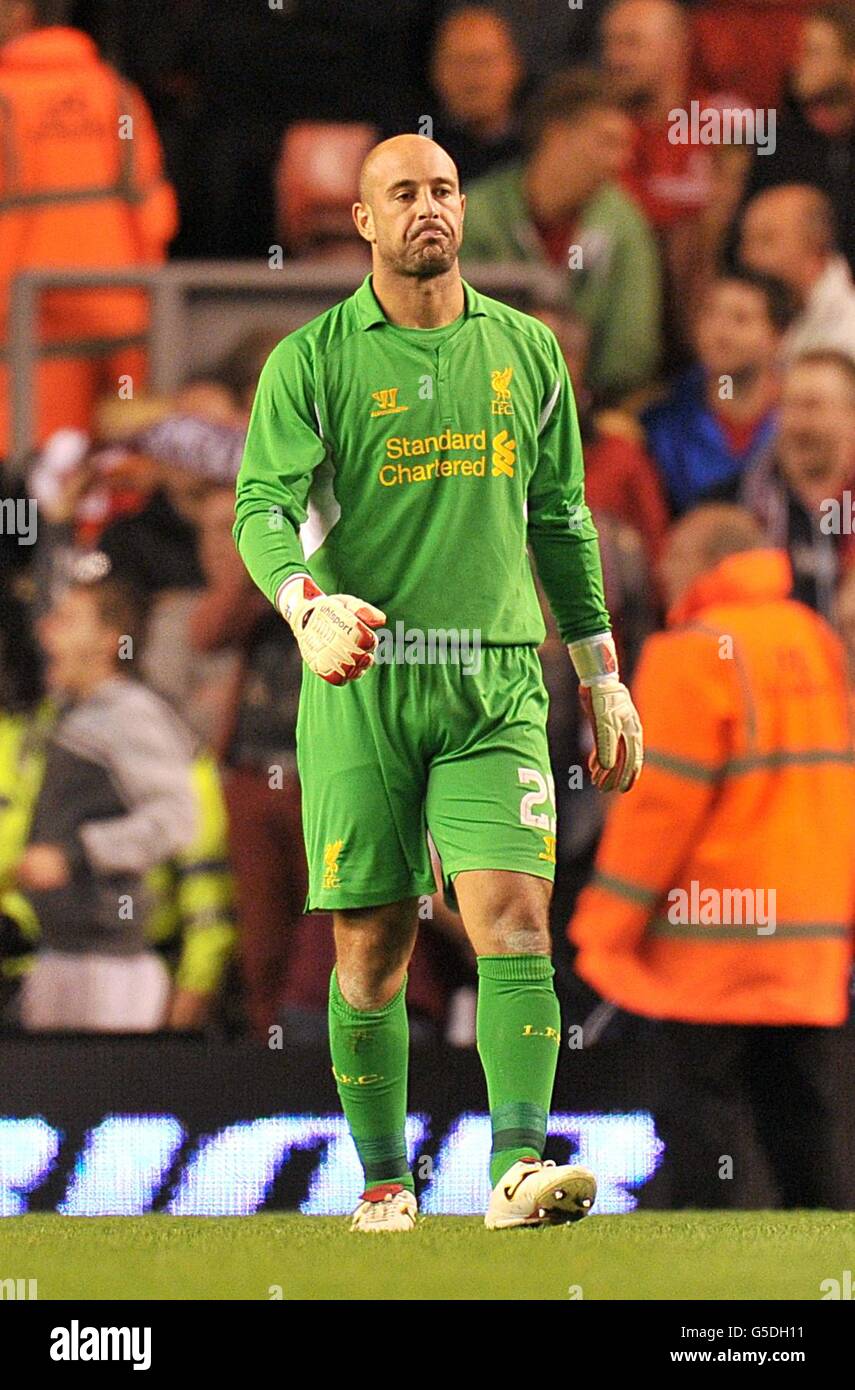 Liverpool goalkeeper Jose Reina stands dejected after his error cost ...