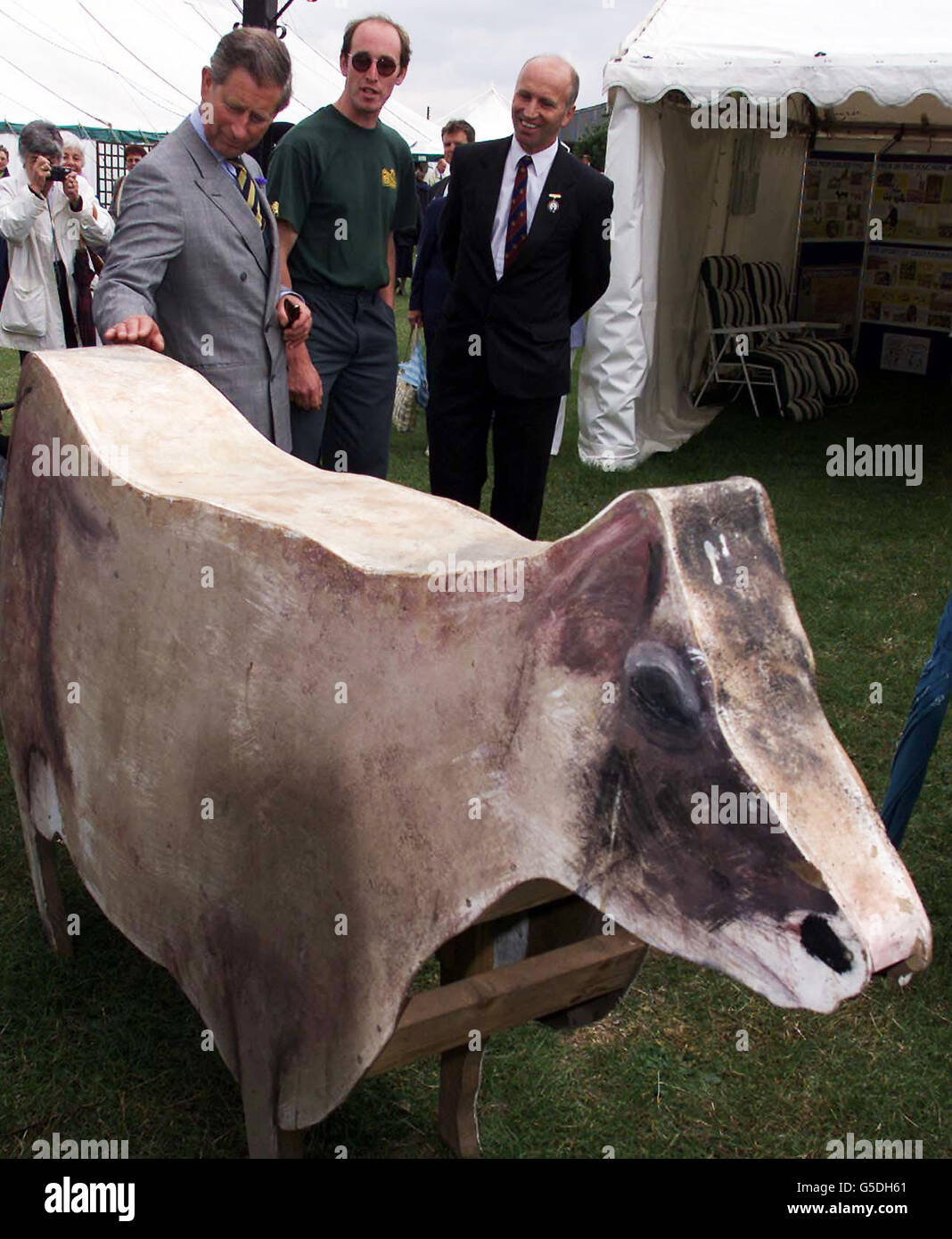 HRH Prince of Wales takes a closer look at a wooden cow as he visits ...