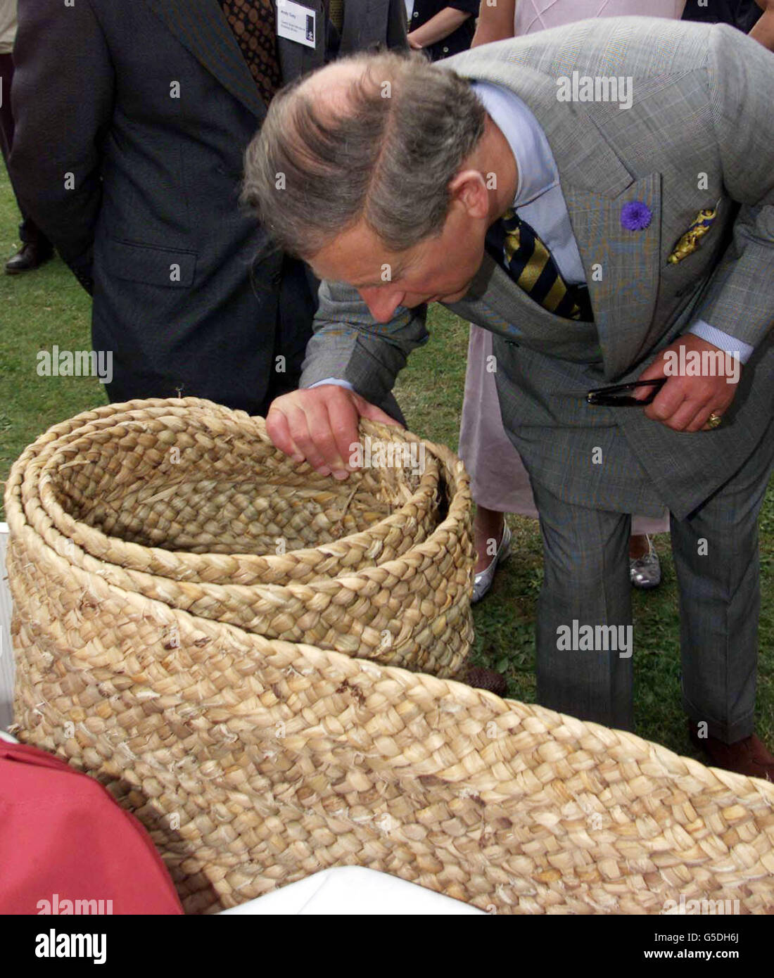 HRH Prince of Wales takes a closer look at a rush mat as he visits the ...