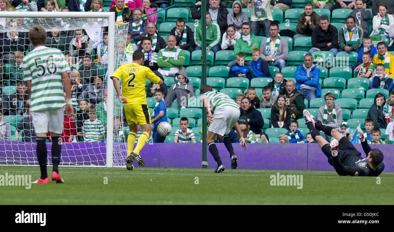 Hibernian's Tim Clancy steals the ball from Celtic's Fraser Forster to ...