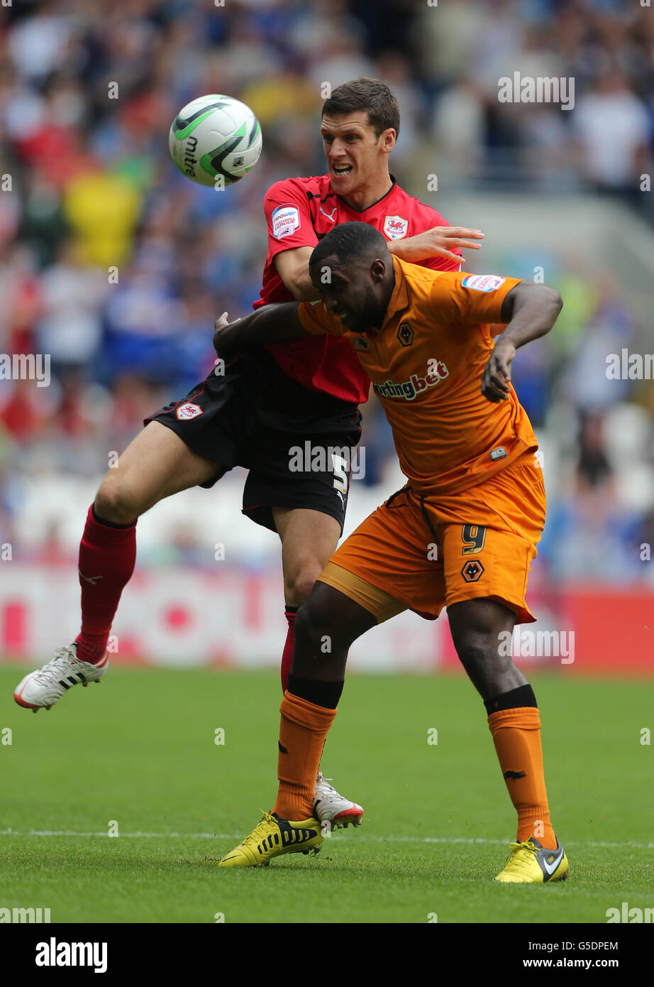 Cardiff City's Mark Hudson (left) holds off a challenge from ...